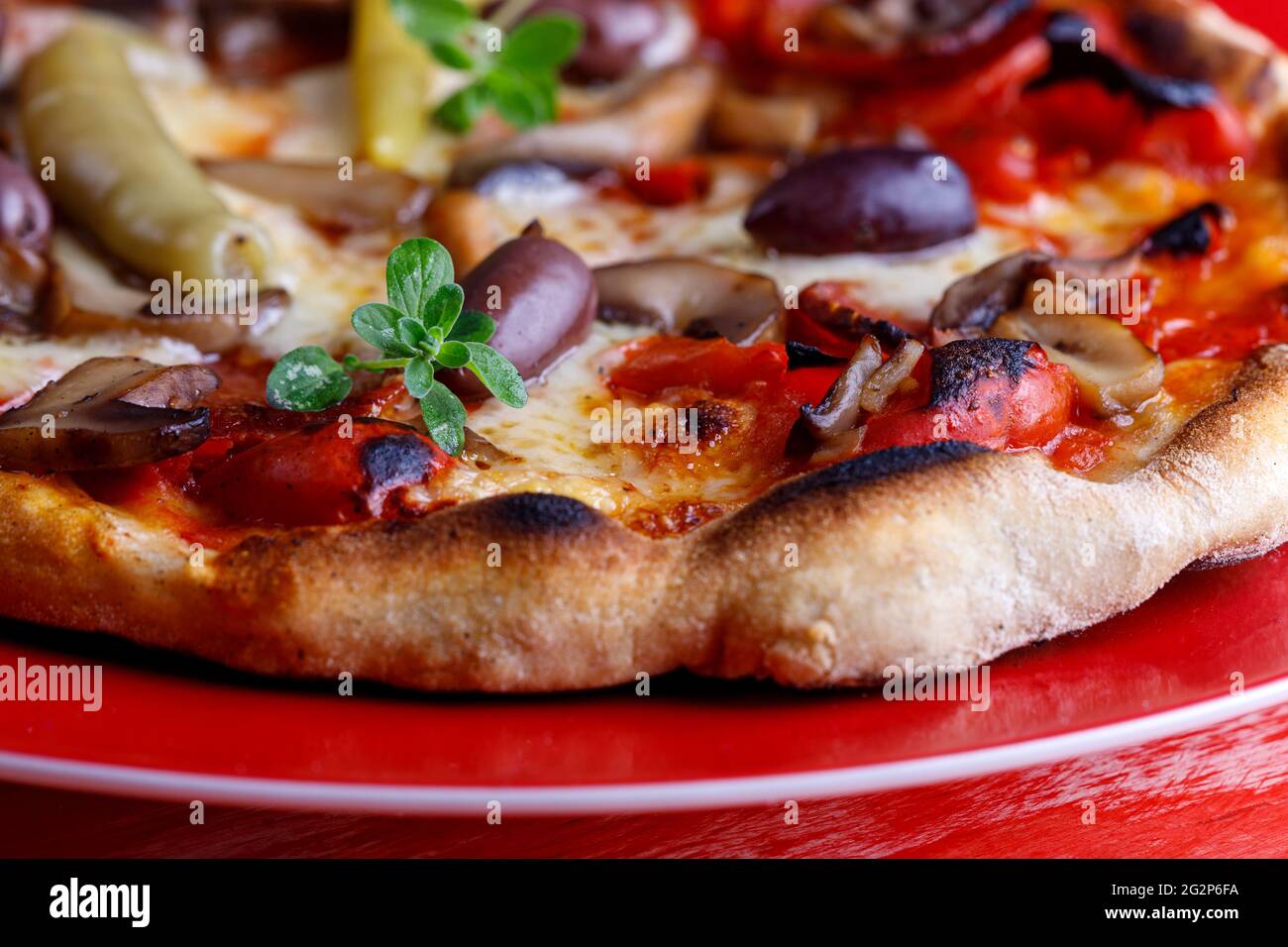 fresh pizza on a red background Stock Photo - Alamy
