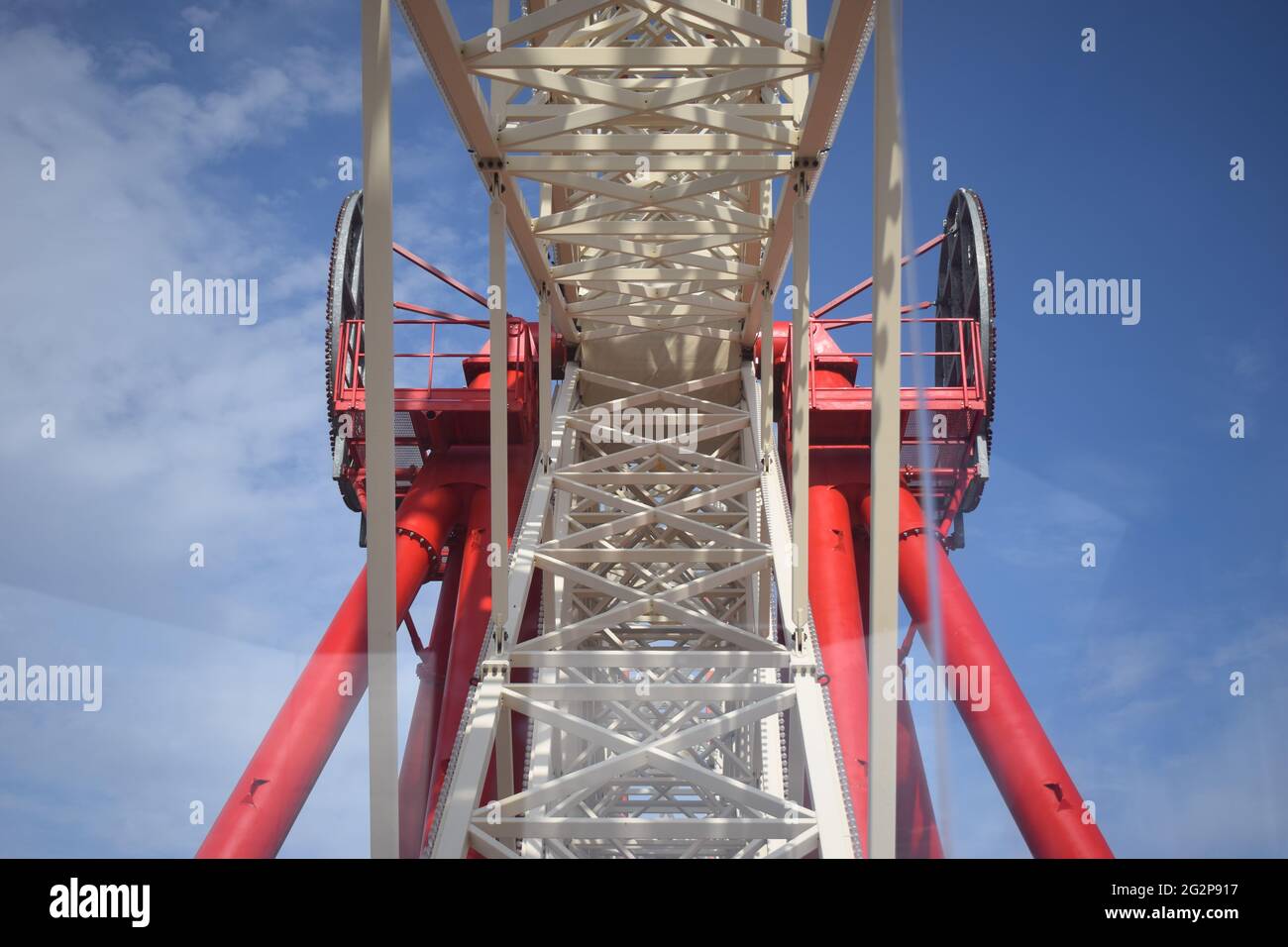 Ferris wheel construction seen from one of the cabins. Part of a white ...