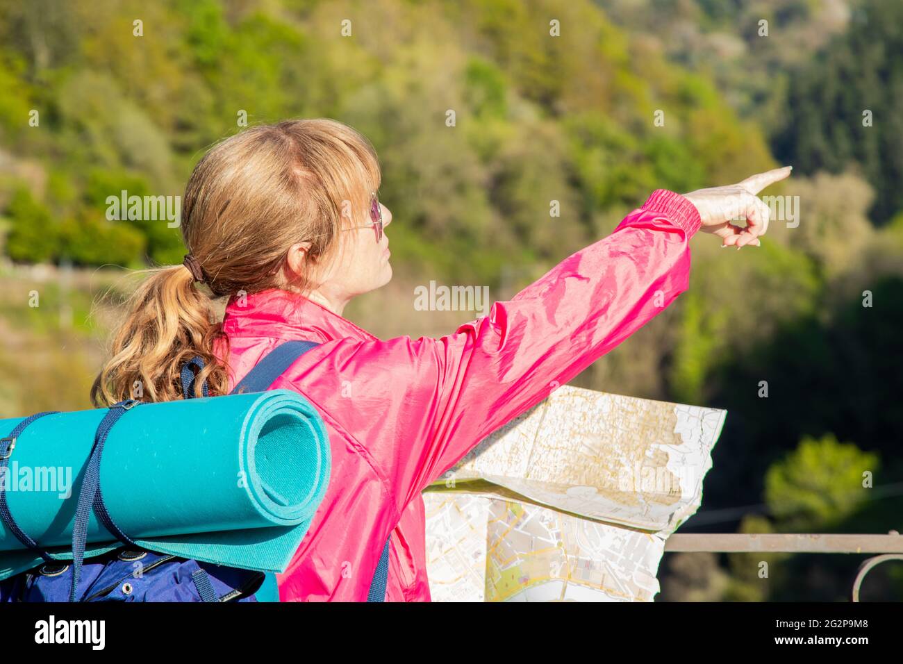 hiking or hiking woman pointing with map Stock Photo - Alamy