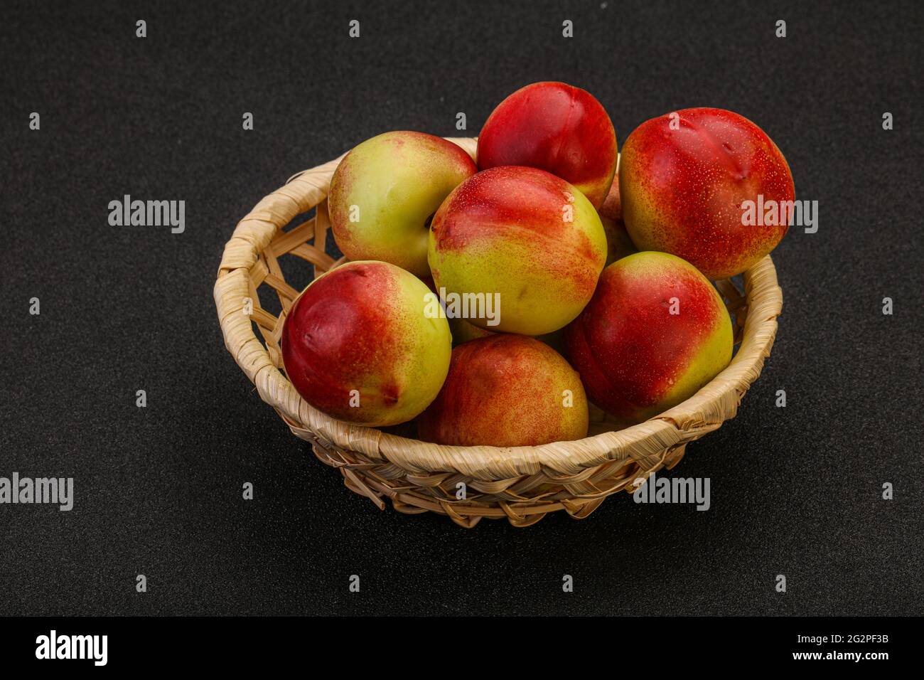 Sweet small green nectarines in the basket Stock Photo - Alamy