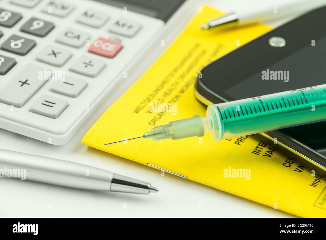 Vaccination certificate and mobile with injection Stock Photo - Alamy