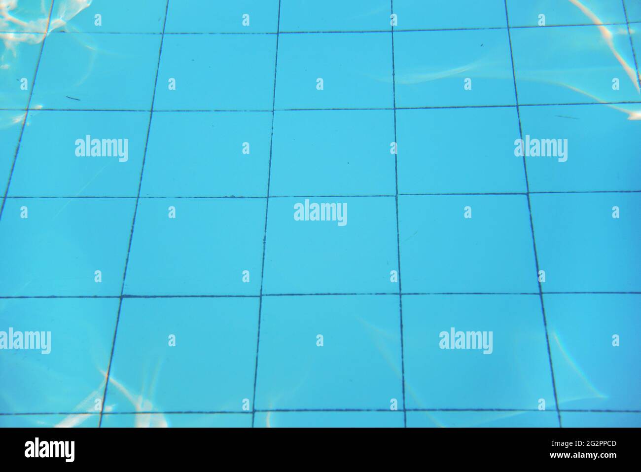 Azure blue swimming pool old tiled floor, sun reflects on ground ...