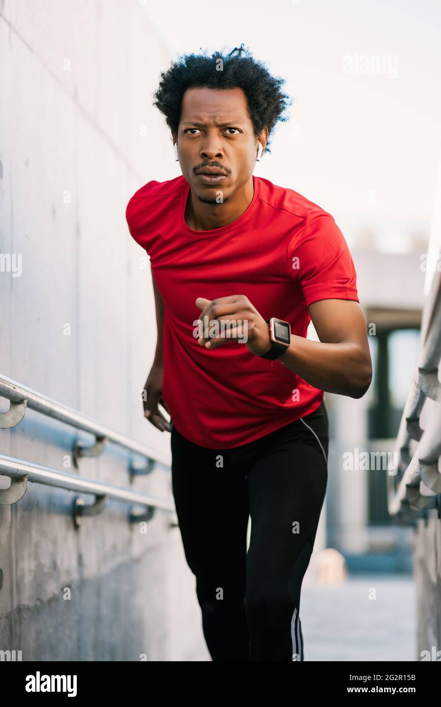 Athletic man running and doing exercise outdoors Stock Photo - Alamy