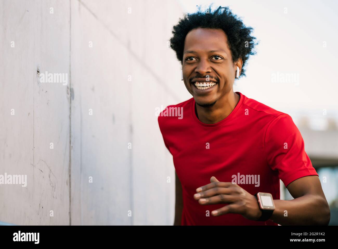 Athletic man running and doing exercise outdoors Stock Photo - Alamy