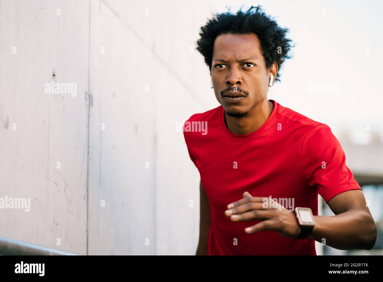 Athletic man running and doing exercise outdoors Stock Photo - Alamy