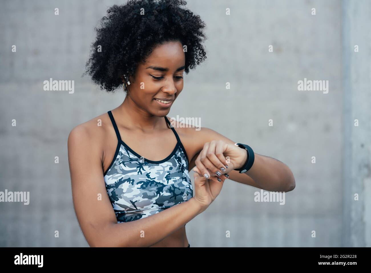 Fitness woman checking time on smart watch Stock Photo - Alamy