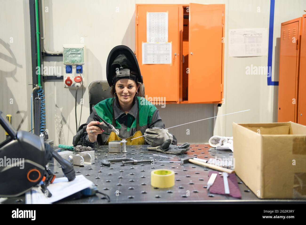 A woman employed in a modern factory for the production and processing ...