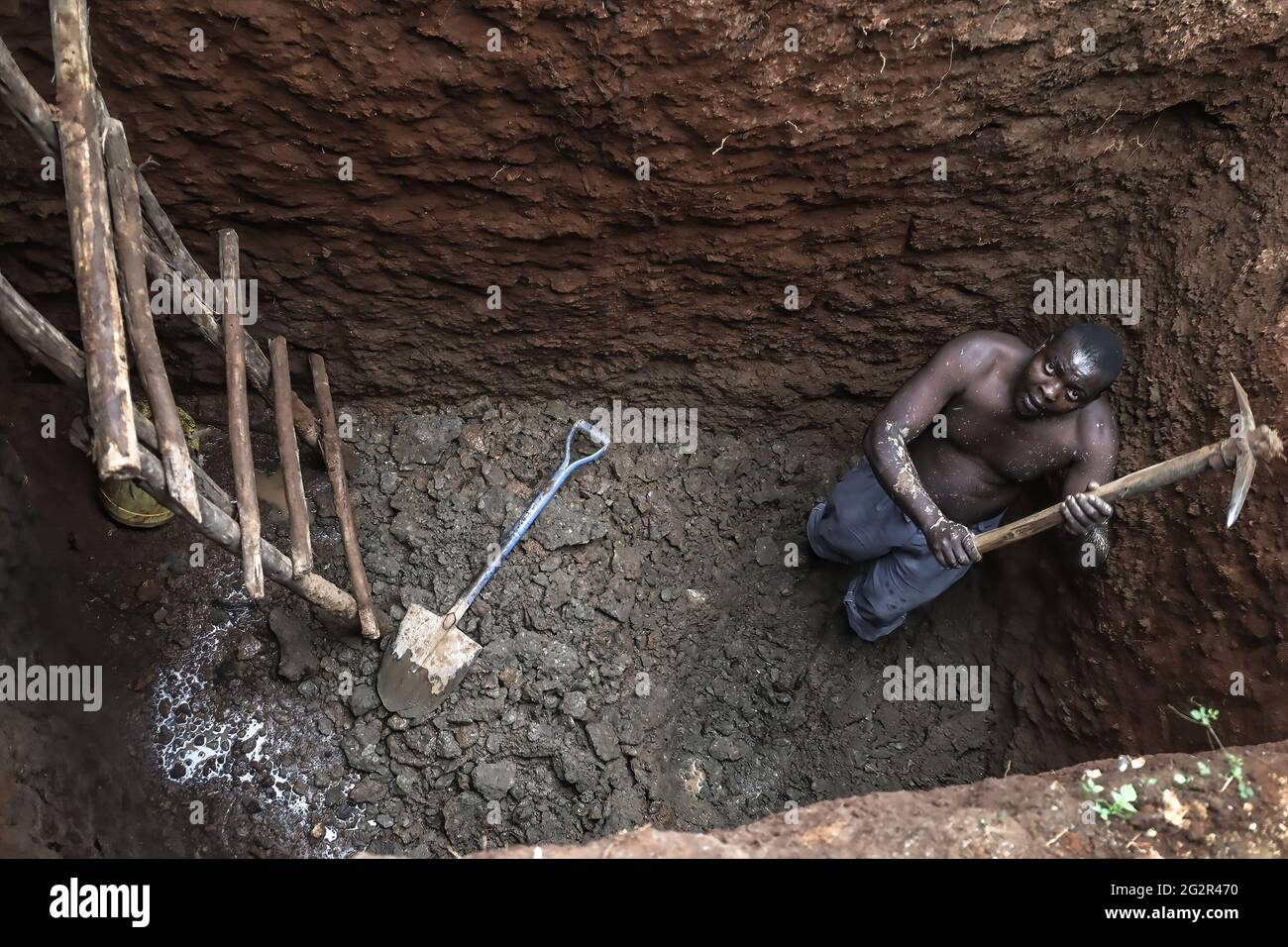 Nairobi, Kenya. 04th June, 2021. A man digs a pit Latrine in Kibera ...