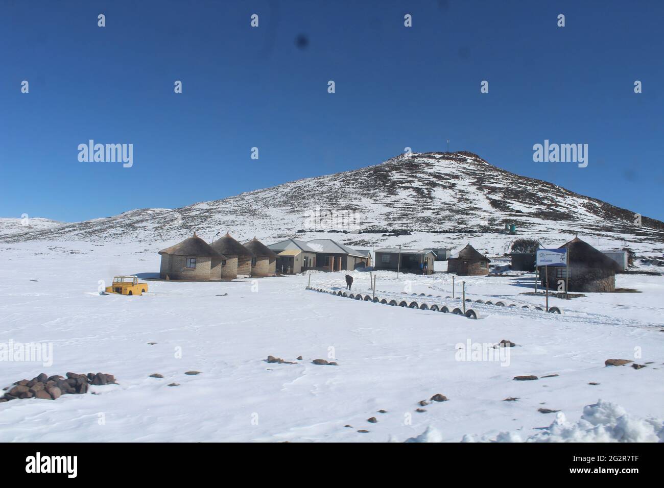 A bodyguard fixes Basotho Action Party leader Nqosa Mahao's face mask ...