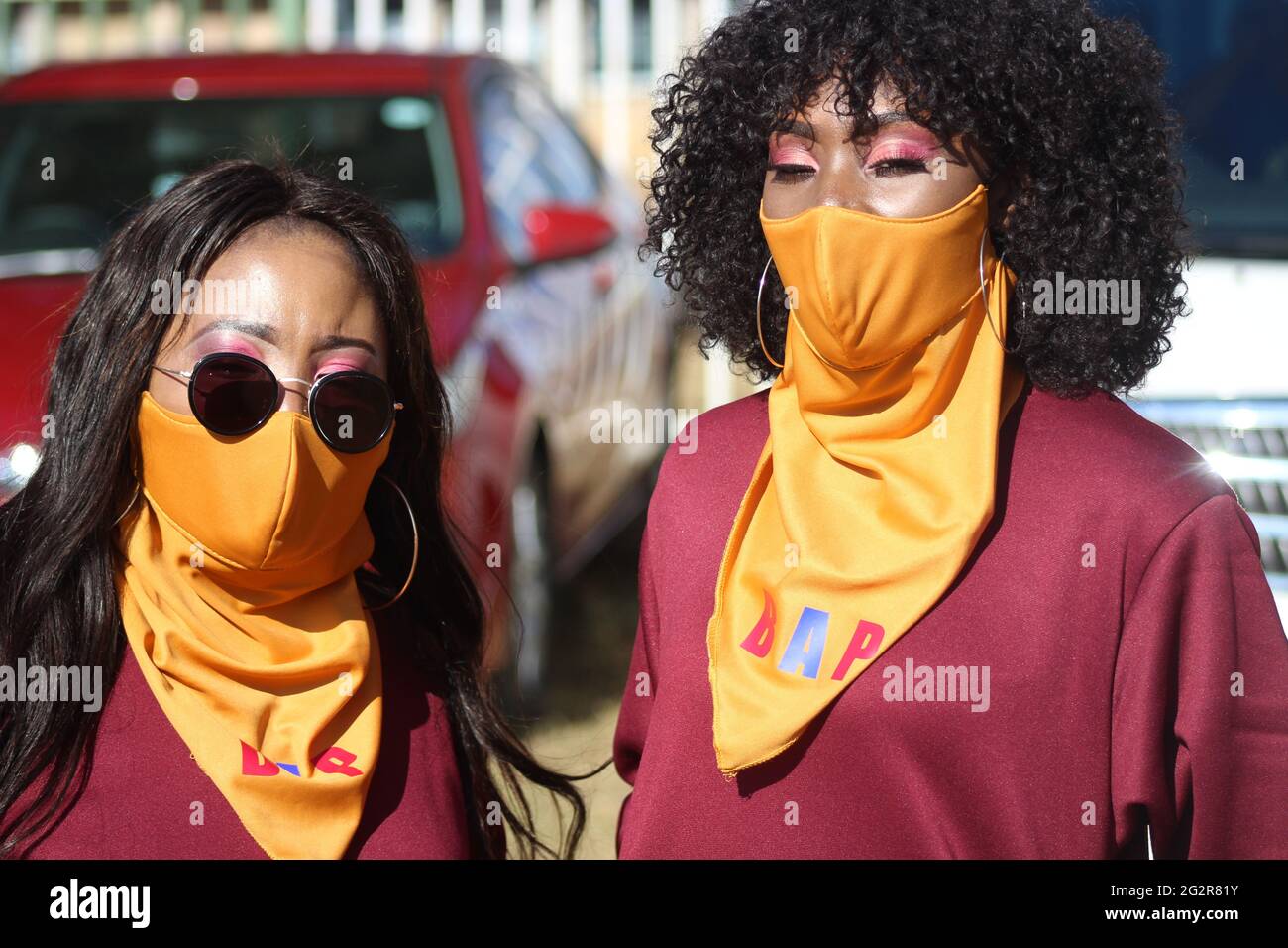 A bodyguard fixes Basotho Action Party leader Nqosa Mahao's face mask ...