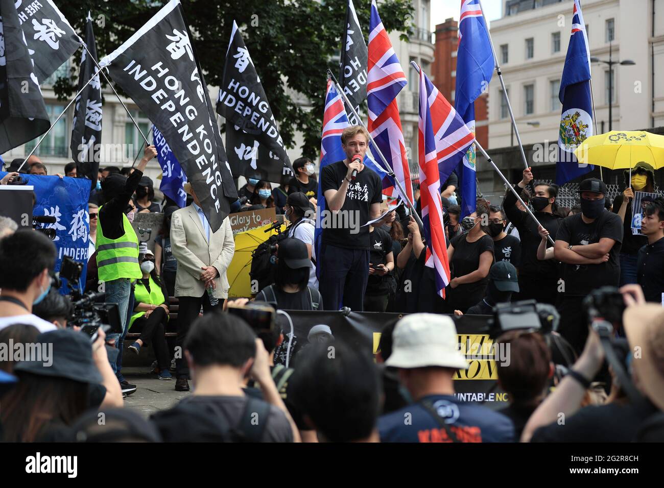 Pro-democracy activist Luke de Pulford speaks during a rally marking ...