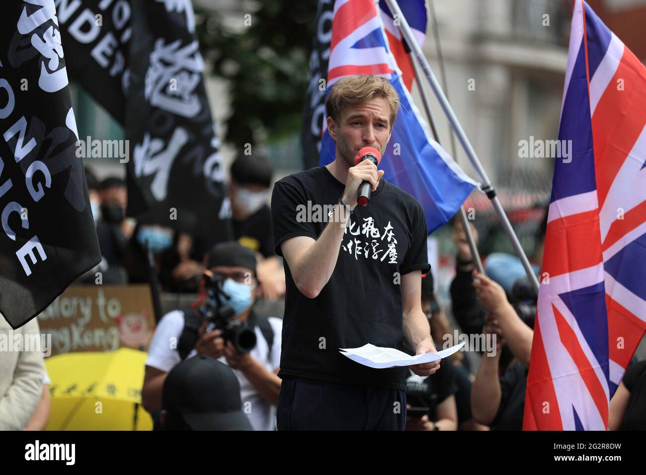 Pro-democracy activist Luke de Pulford speaks during a rally marking ...