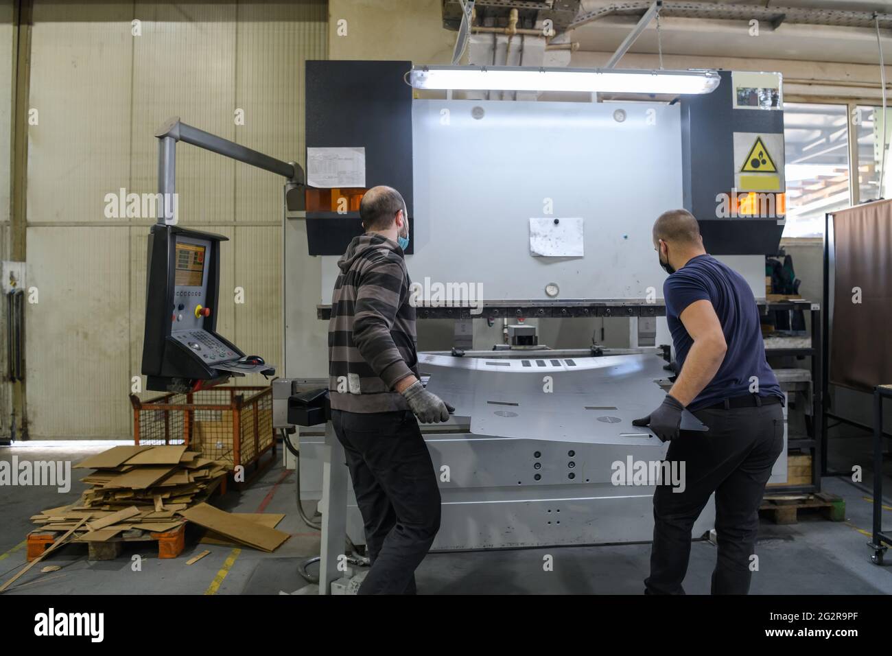 Cnc machine and workers with mask hi-res stock photography and images ...
