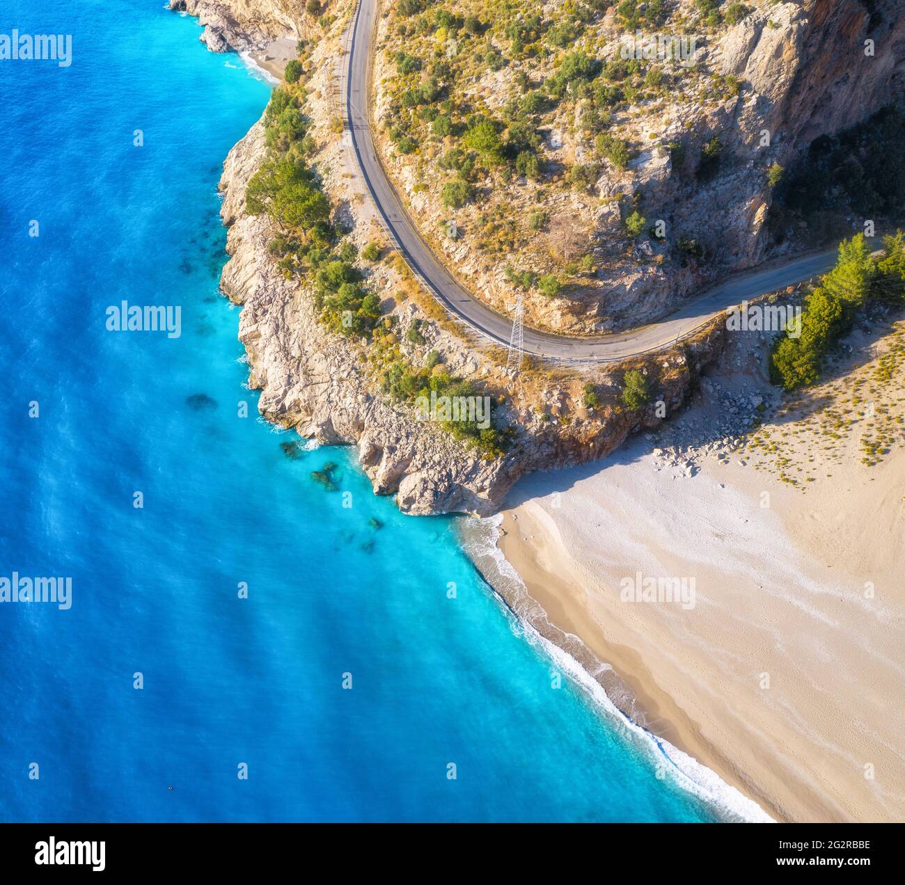 Aerial view of mountain road near blue sea with sandy beach Stock Photo ...