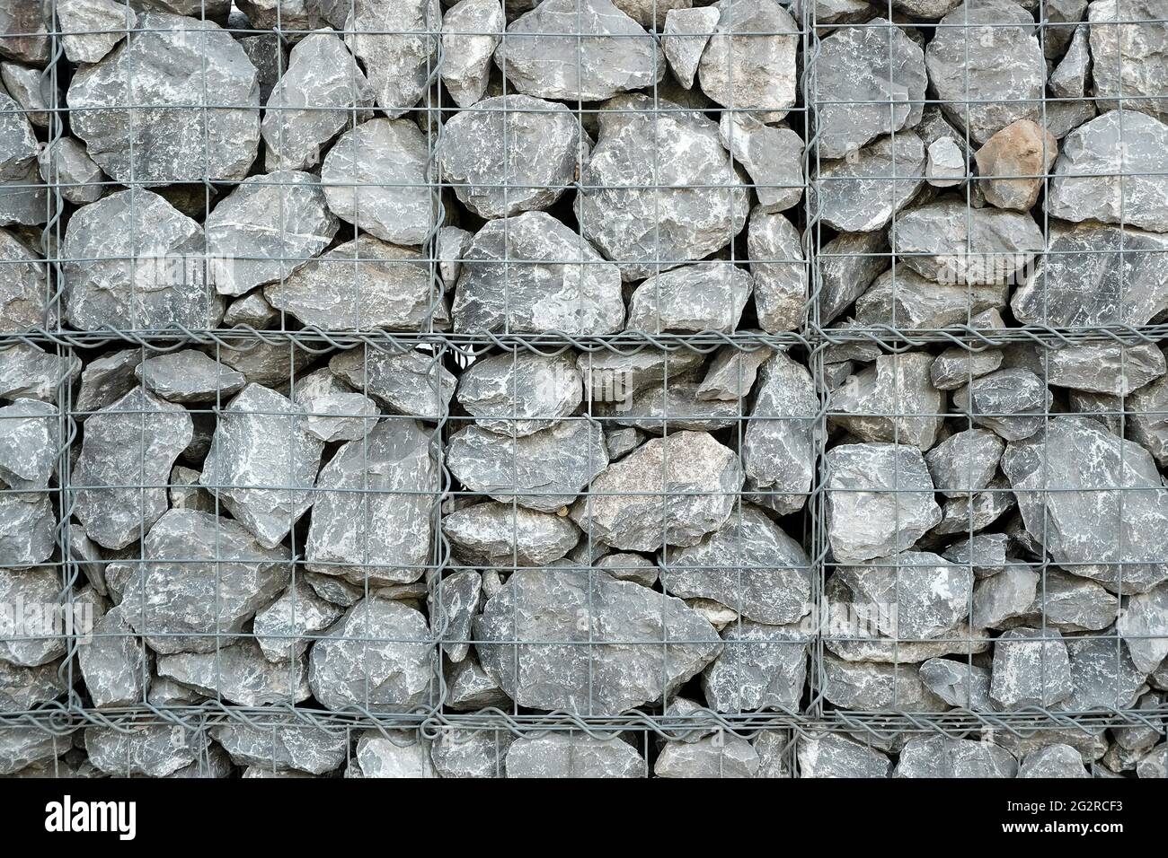 Closeup shot of stones behind a metal fence Stock Photo - Alamy