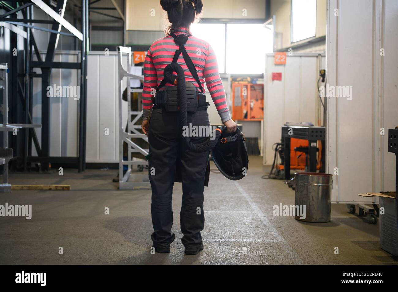 A female welder preparing for a working day in the metal processing ...