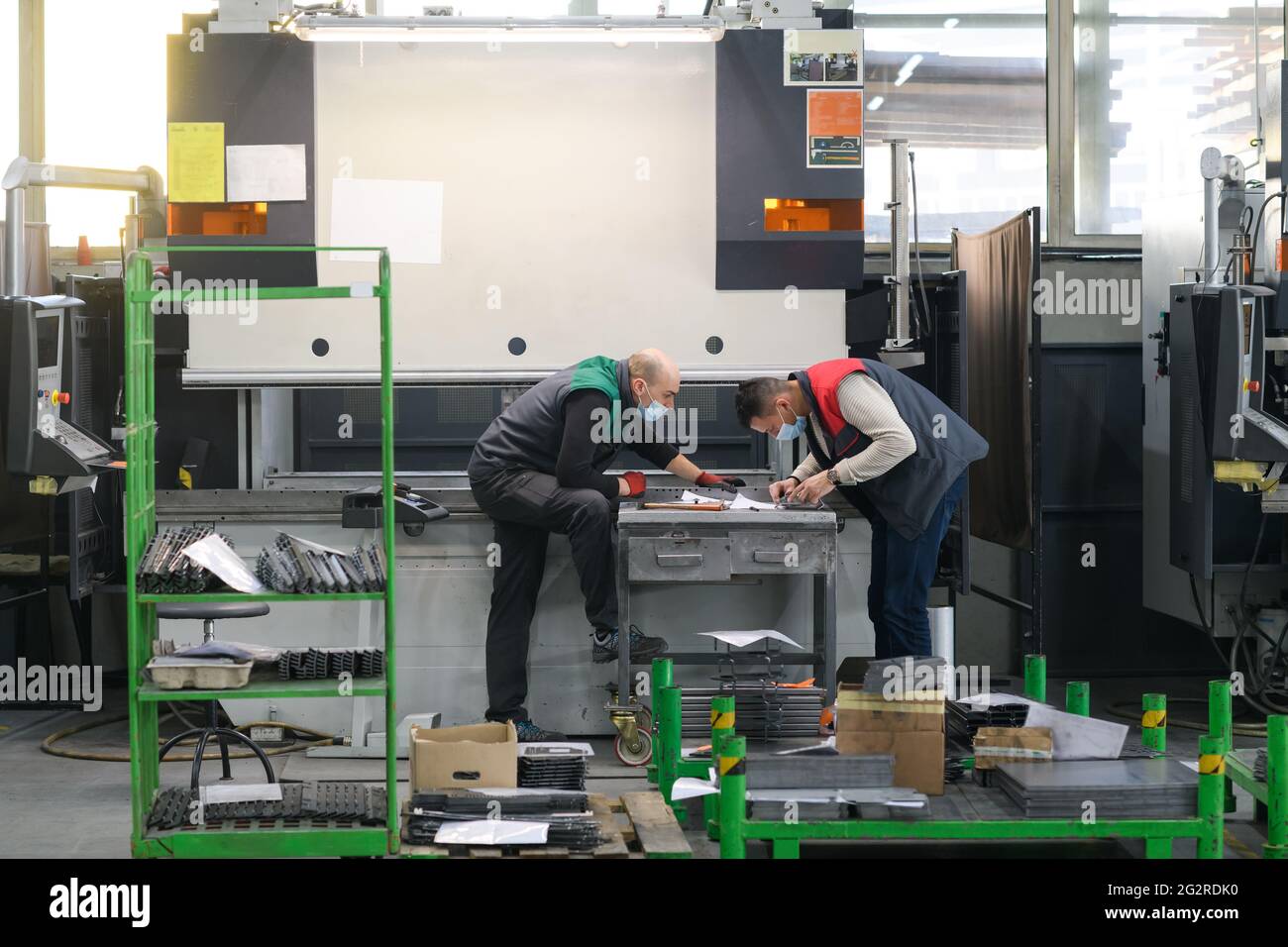 Cnc machine and workers with mask hi-res stock photography and images ...