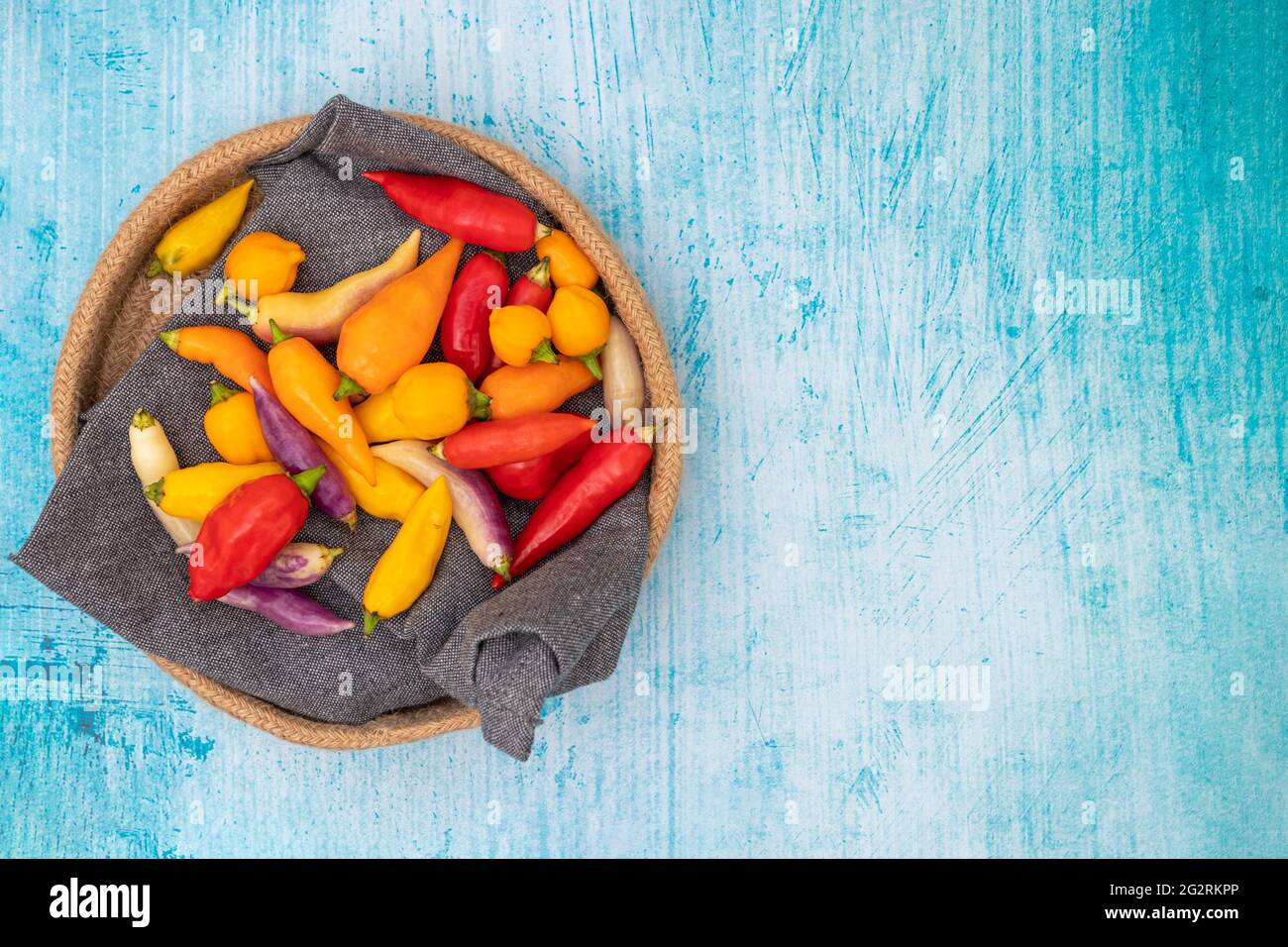 Peruvian chili peppers of various colors on blue background Stock Photo ...