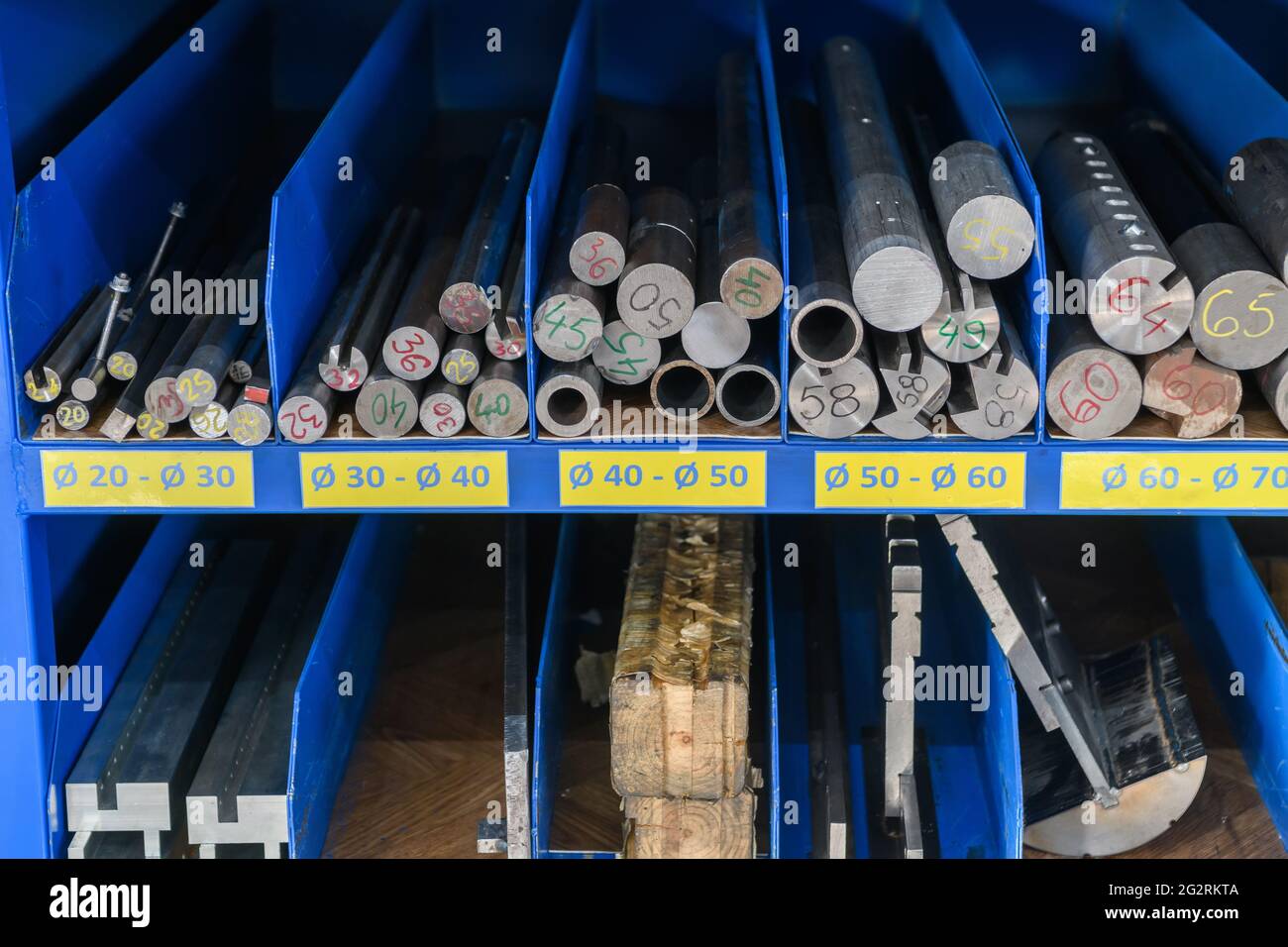 pipes, metal pieces and various metal parts for a CNC machine standing ...