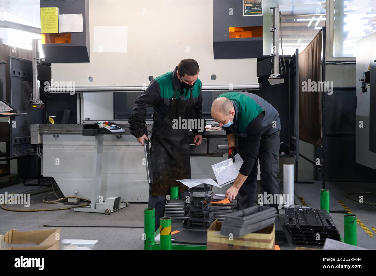 Cnc machine and workers with mask hi-res stock photography and images ...