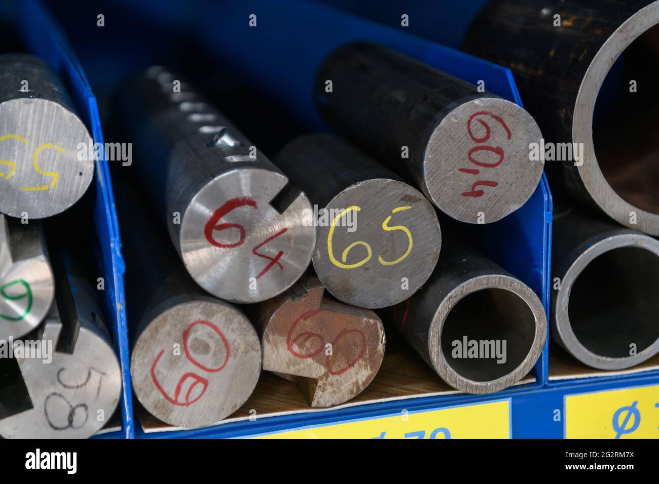 pipes, metal pieces and various metal parts for a CNC machine standing ...