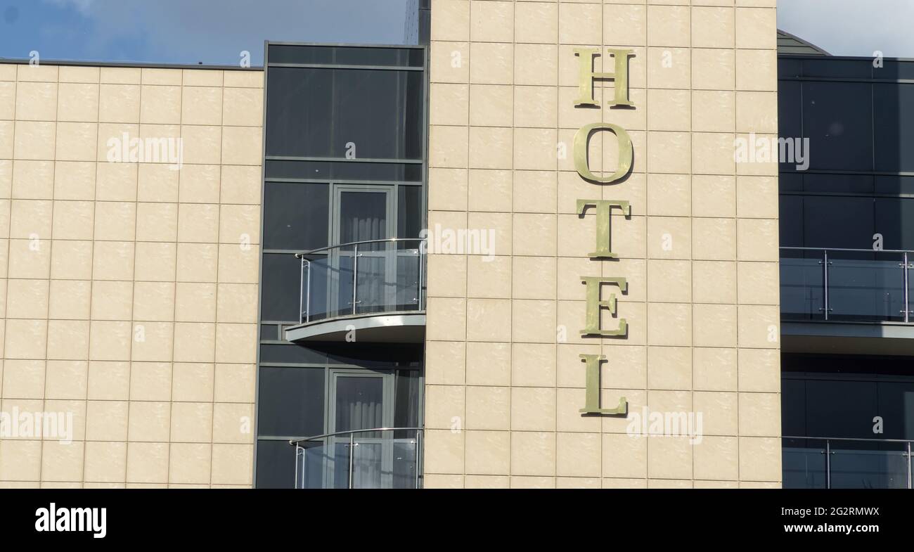 Vertical Hotel signboard over the entrance to the building. Vertical ...