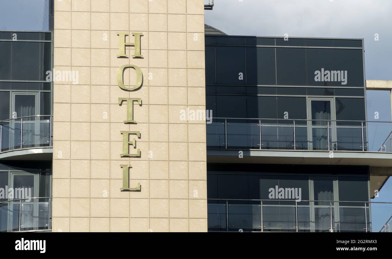 Vertical Hotel signboard over the entrance to the building. Vertical ...