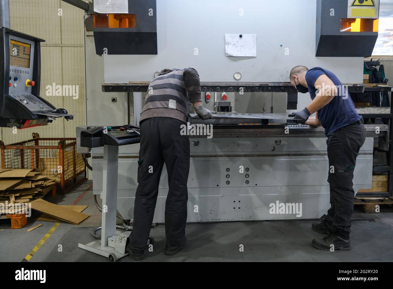 Cnc machine and workers with mask hi-res stock photography and images ...