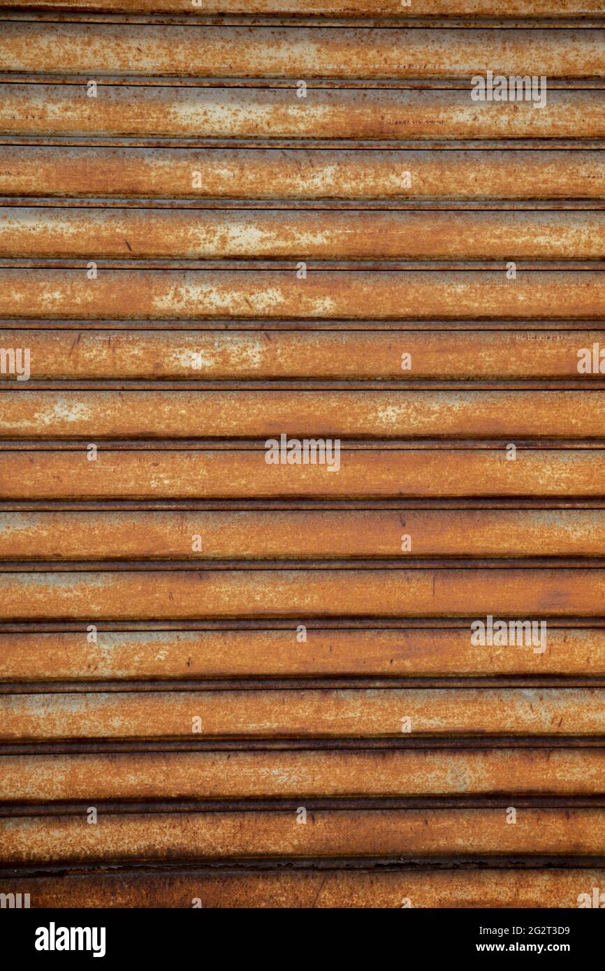 a rusty degrayded shop shutter, closed Stock Photo - Alamy