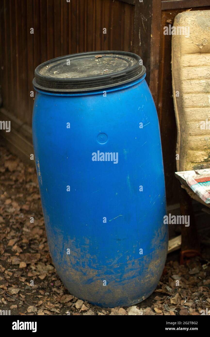 Blue storage barrel. The oil barrel is on the ground. The use of a ...