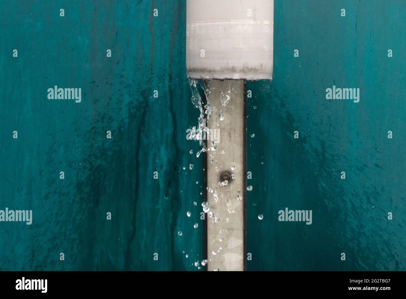 Water is pouring out of the drain. Drain pipe on the street. Drainage ...
