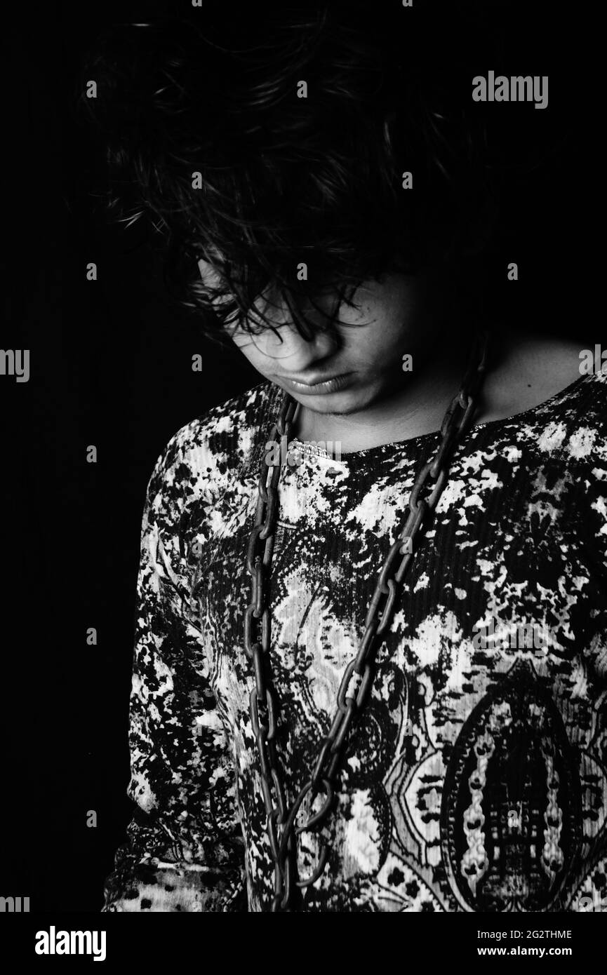 Grayscale shot of a handsome guy posing chained up Stock Photo - Alamy