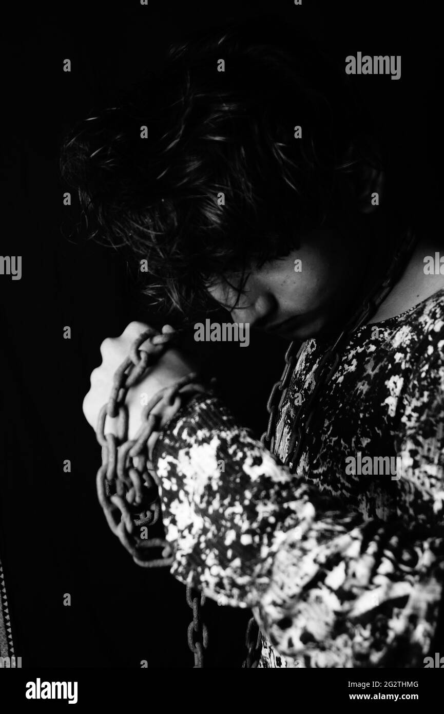 Grayscale shot of a handsome guy posing chained up Stock Photo - Alamy