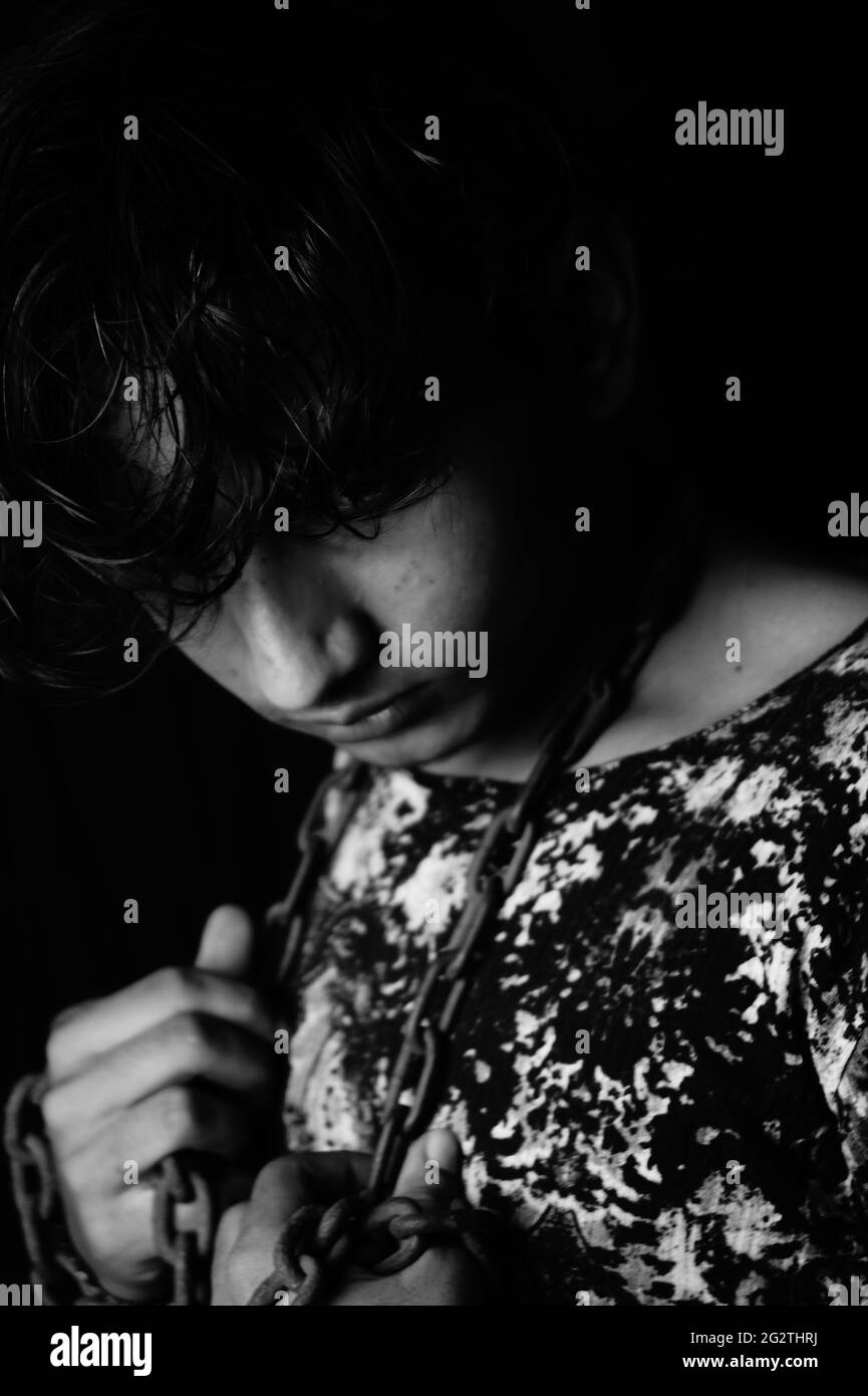 Grayscale shot of a handsome guy posing chained up Stock Photo - Alamy