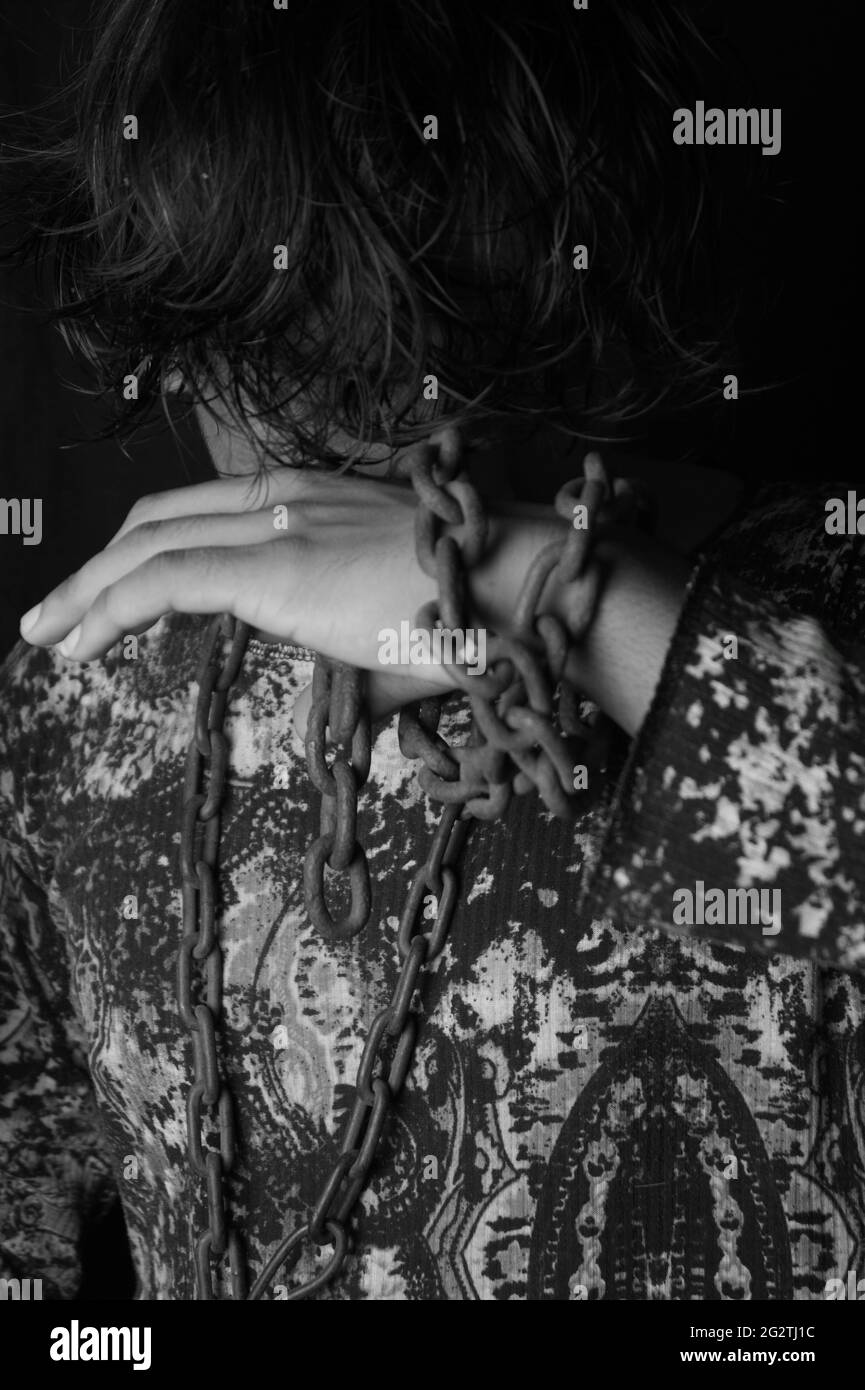 Grayscale shot of a handsome guy posing chained up Stock Photo - Alamy