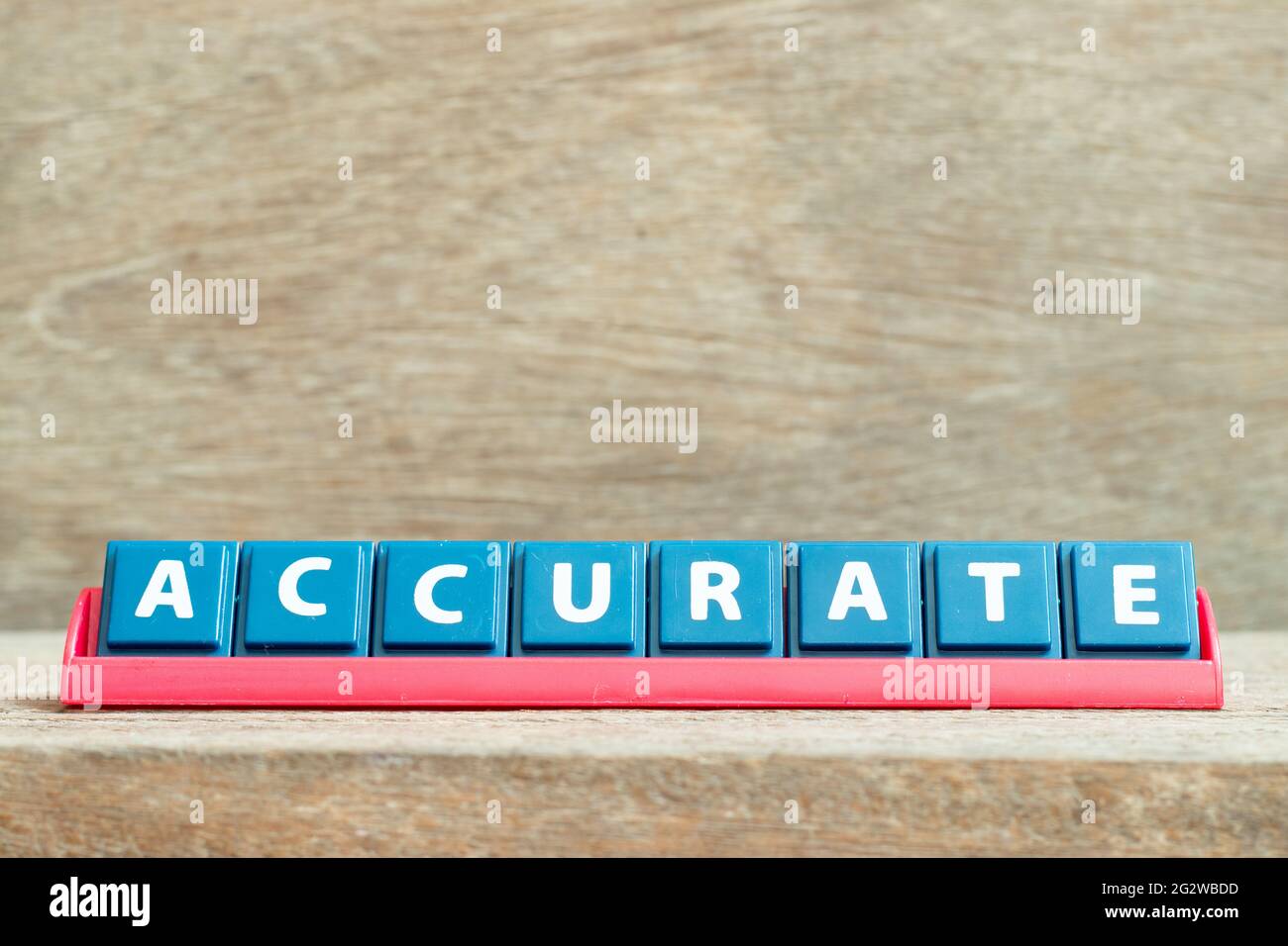 Tile alphabet letter with word accurate in red color rack on wood ...