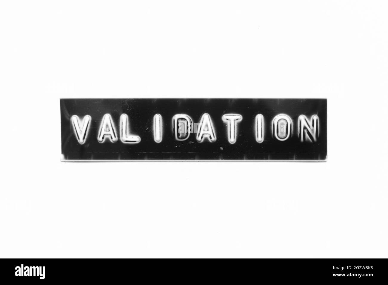 Embossed letter with word validation in black banner on white paper ...
