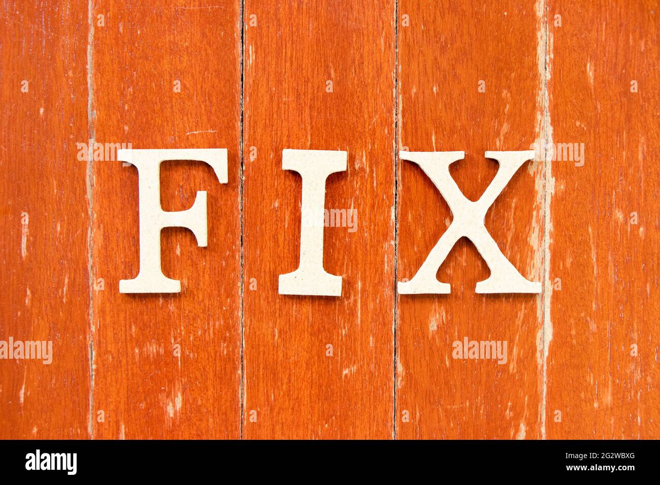 Alphabet letter in word fix on old red color wood plate background ...