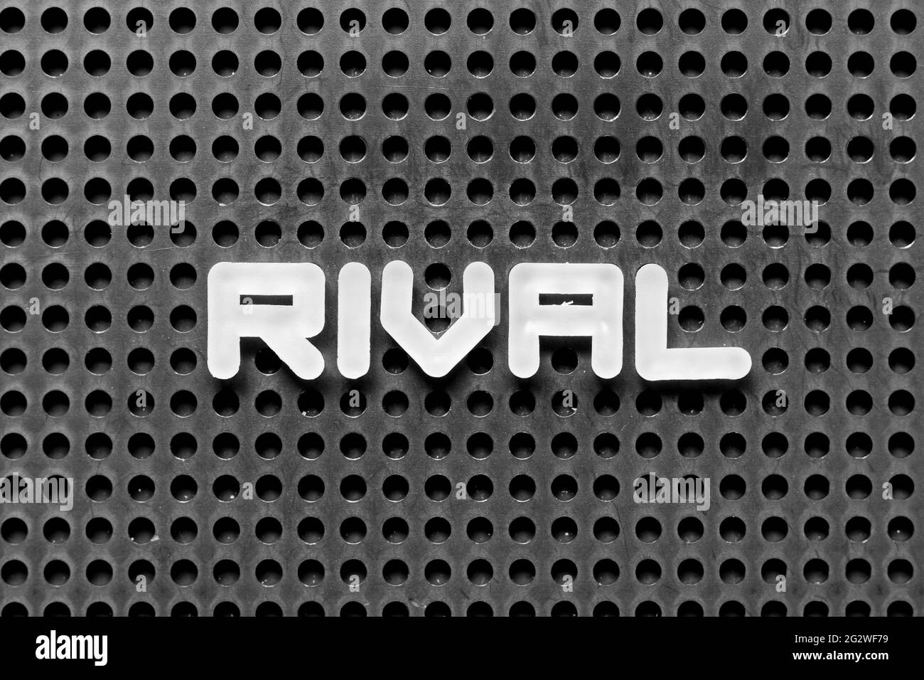 White alphabet letter in word rival on black pegboard background Stock ...