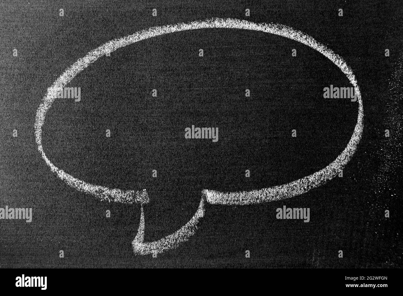 White color chalk hand drawing in round bubble speech shape with blank ...