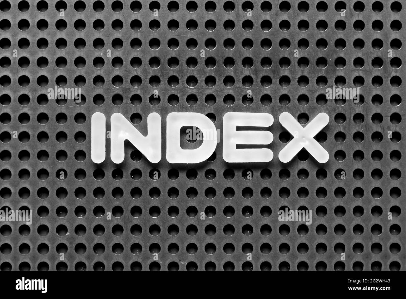 White alphabet letter in word index on black pegboard background Stock ...