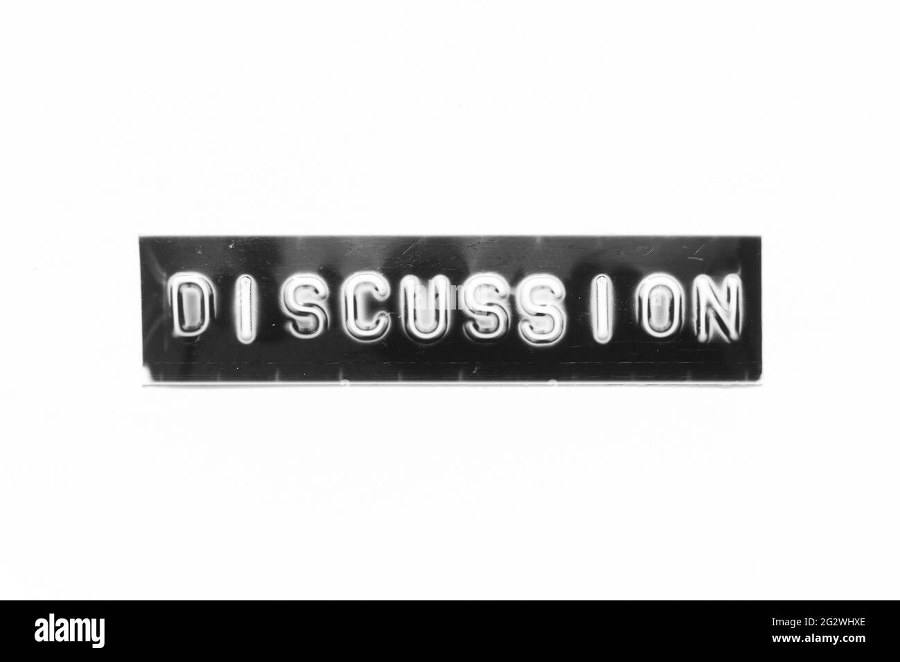 Embossed letter with word discussion in black banner on white paper ...