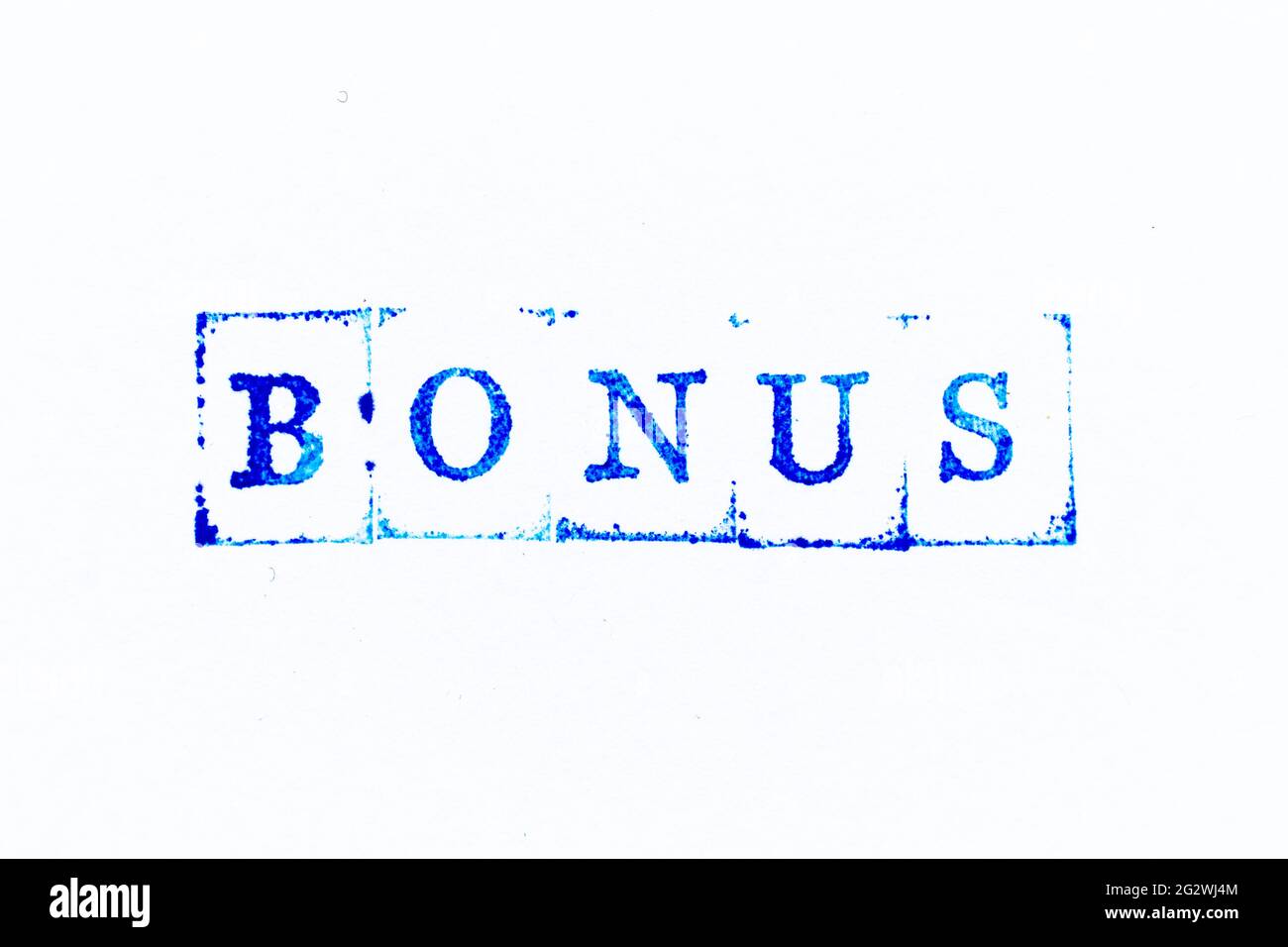 Blue color ink rubber stamp in word bonus on white paper background ...