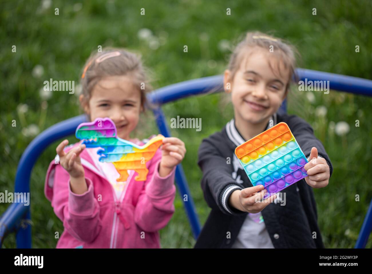 Little girls playing a new fidget toy popular with children helps them ...