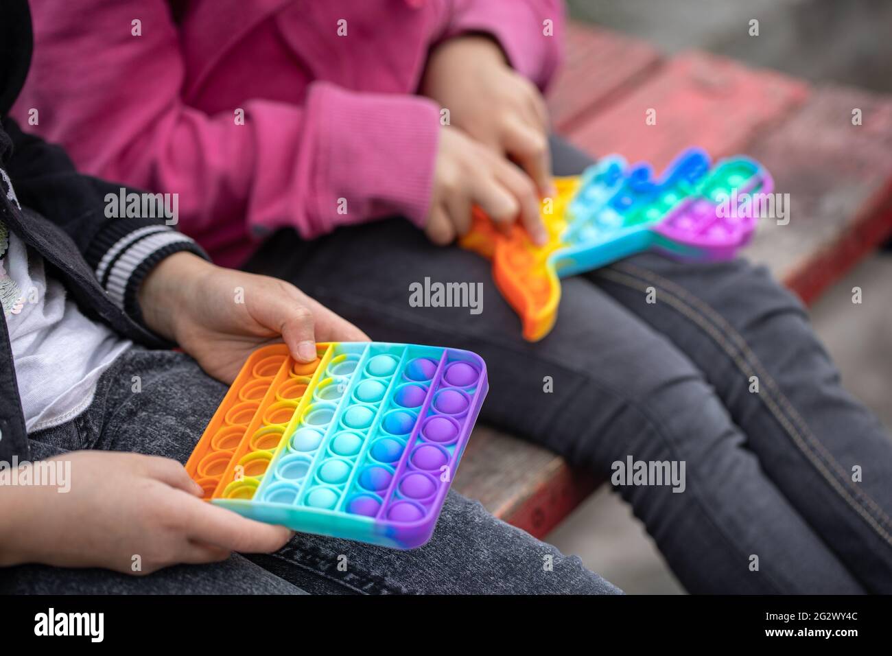 Little girls playing a new fidget toy popular with children helps them ...