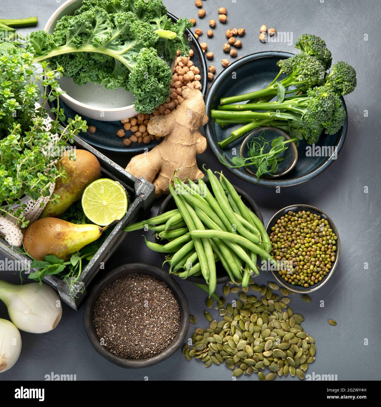 Assorted green vegetables and cereal on gray background. Healthy food ...