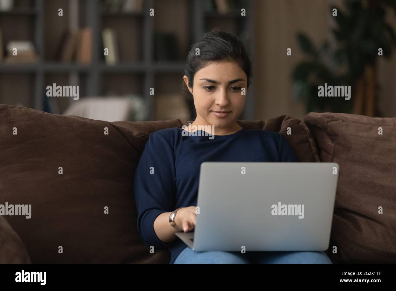 Focused indian female remote worker do online job using computer Stock ...