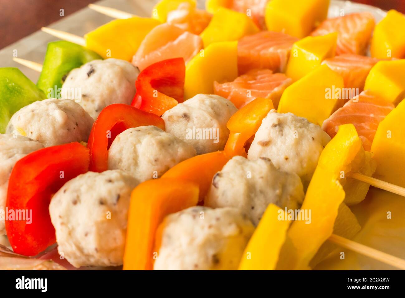 Skewers with fish balls and bell peppers and salmon with mango for ...