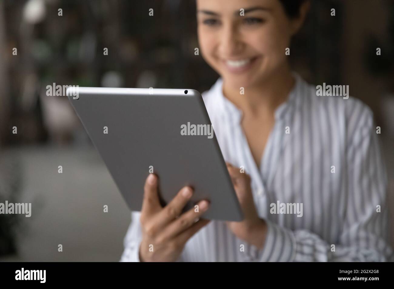 Happy young indian woman holding using modern tablet computer Stock ...