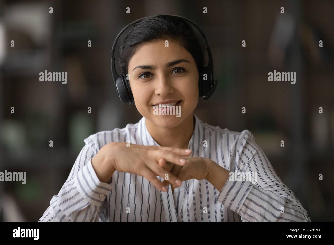 Webcam portrait young indian female in headset client support ...